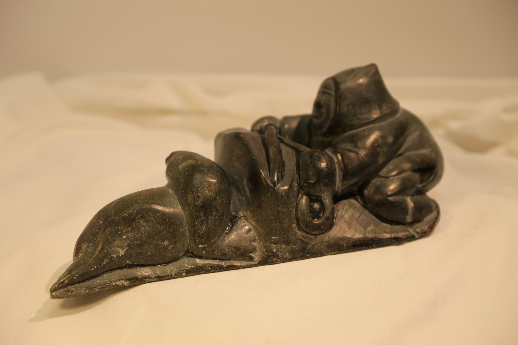 Hunter stalking ringed seal Inuit Carving | Langford Gallery